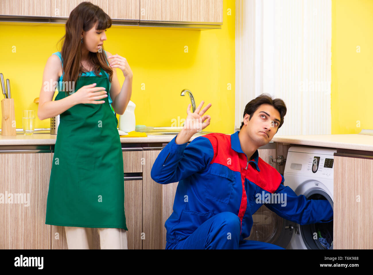 The contractor repairing washing machine at home Stock Photo - Alamy