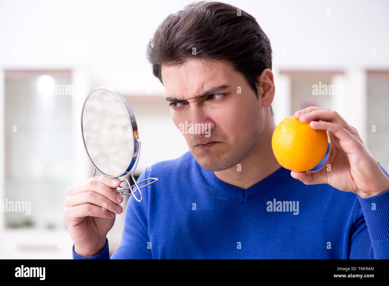 The young handsome man taking care of face skin Stock Photo - Alamy
