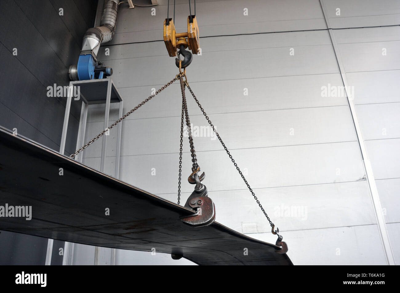Lifting chains and hooks for loading sheet metal. Grab. Industry Stock ...
