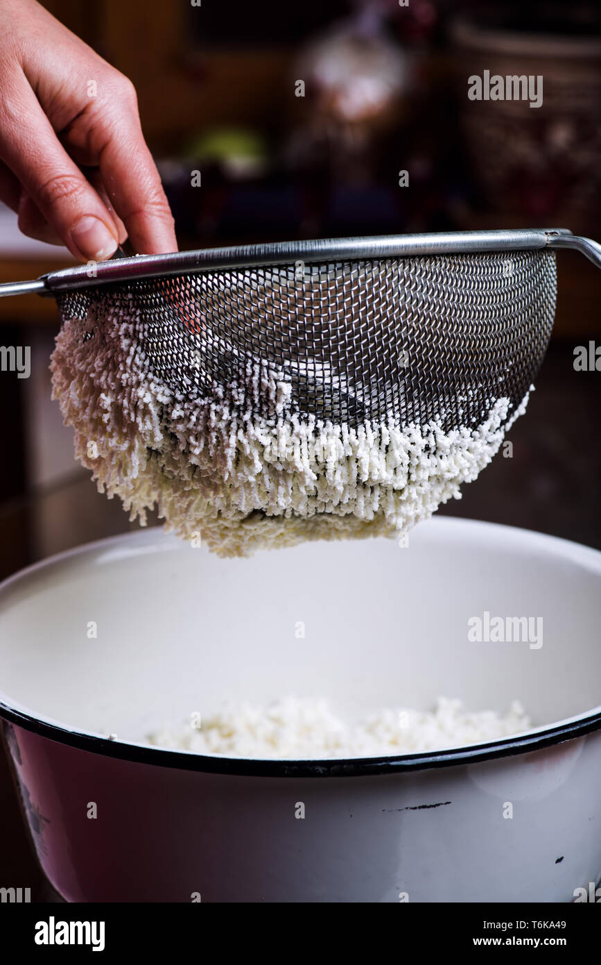 Sieve with cheese. Cooking Cheese Souffle. Close-up Stock Photo - Alamy