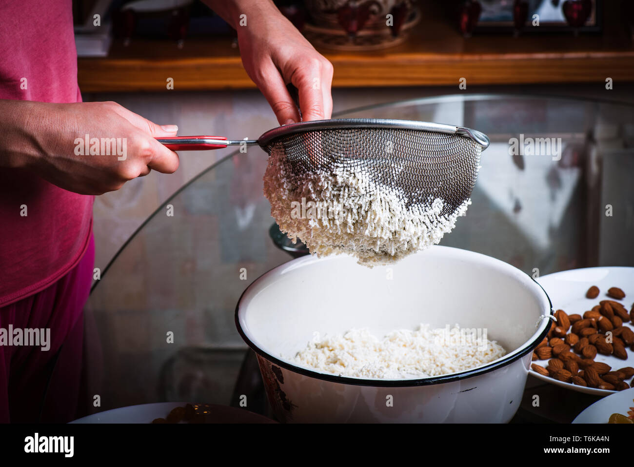 The process of making traditional Easter molded cottage cheese dessert ...