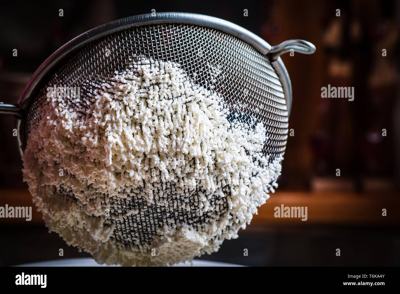 Sieve with cheese. Close-up Stock Photo - Alamy