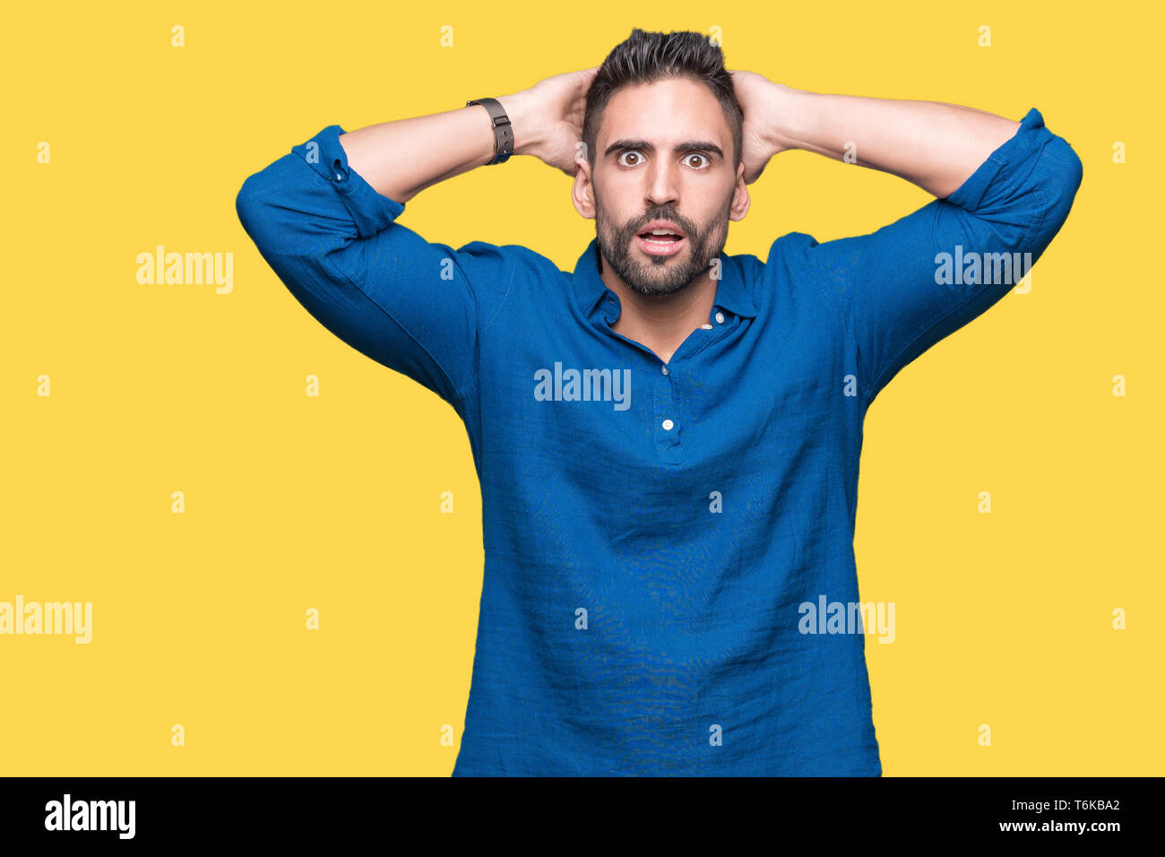 Young handsome man over isolated background Crazy and scared with hands ...