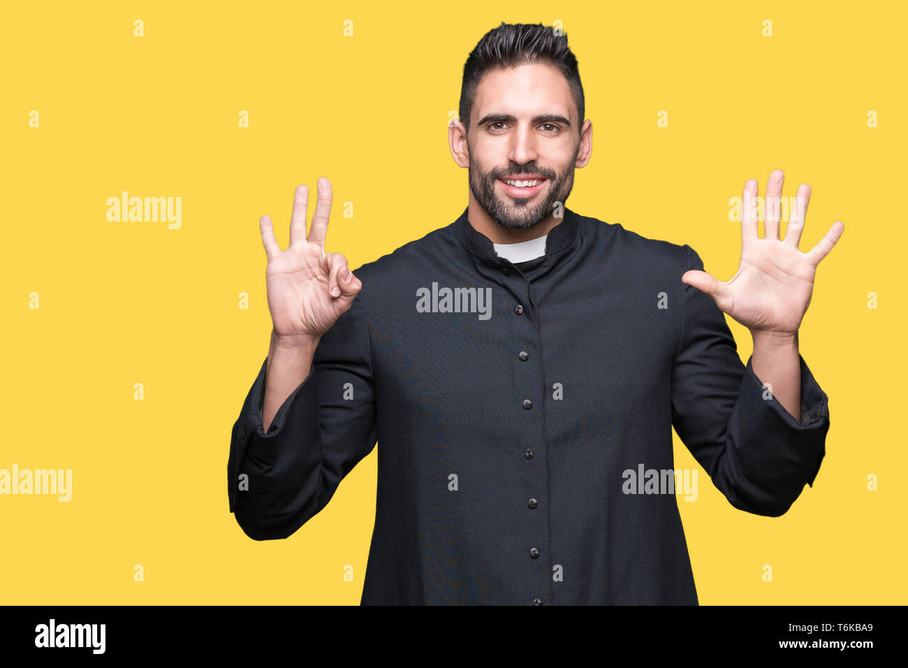 Young Christian priest over isolated background showing and pointing up ...