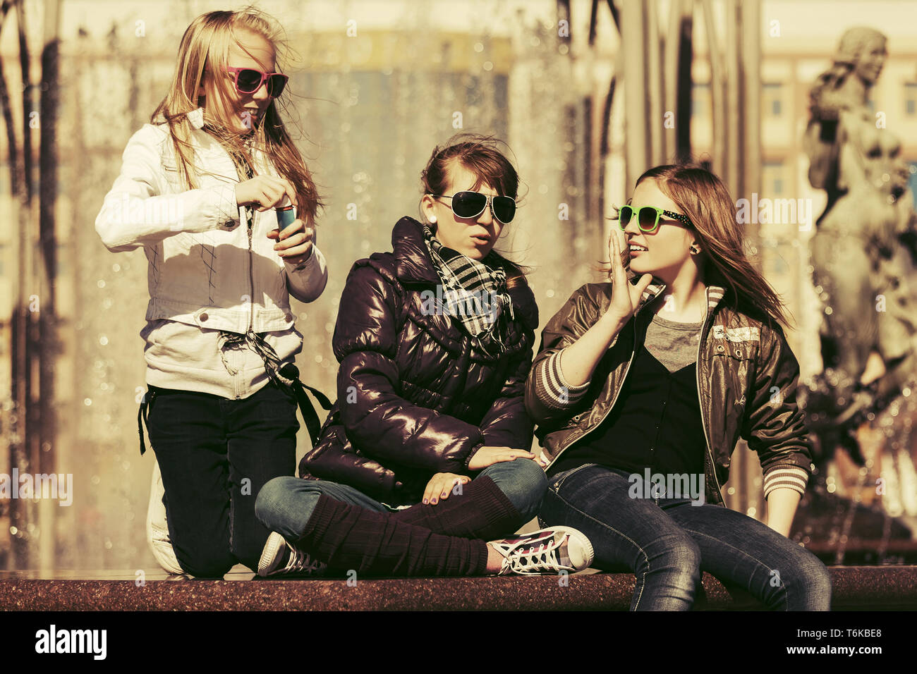 Group of happy teenage girls talking on city street Stock Photo - Alamy