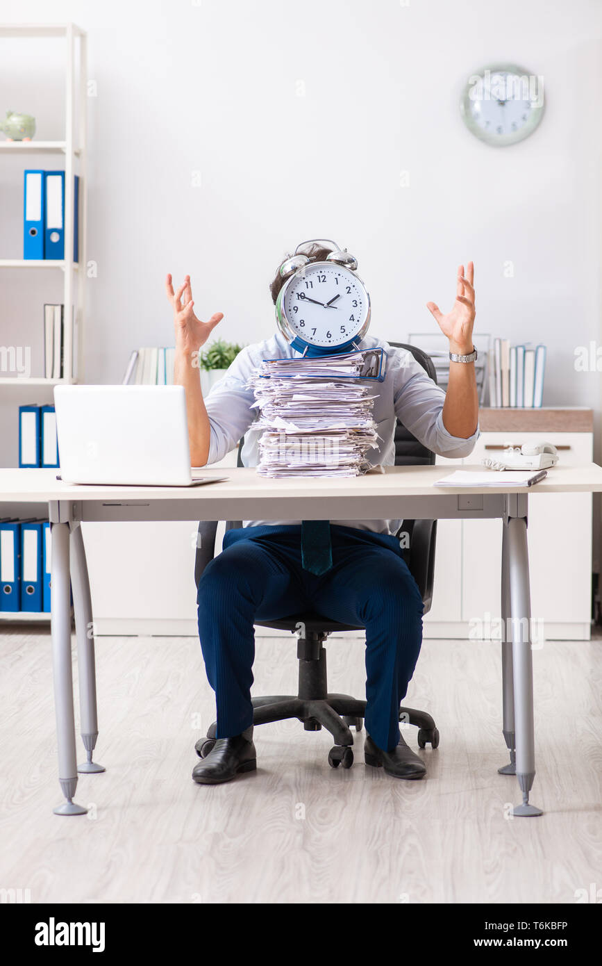 The overloaded busy employee with too much work and paperwork Stock ...