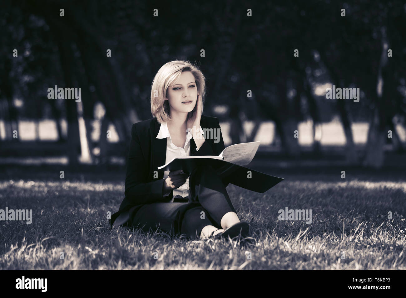 Young business woman with file folder in city park Stylish female model ...