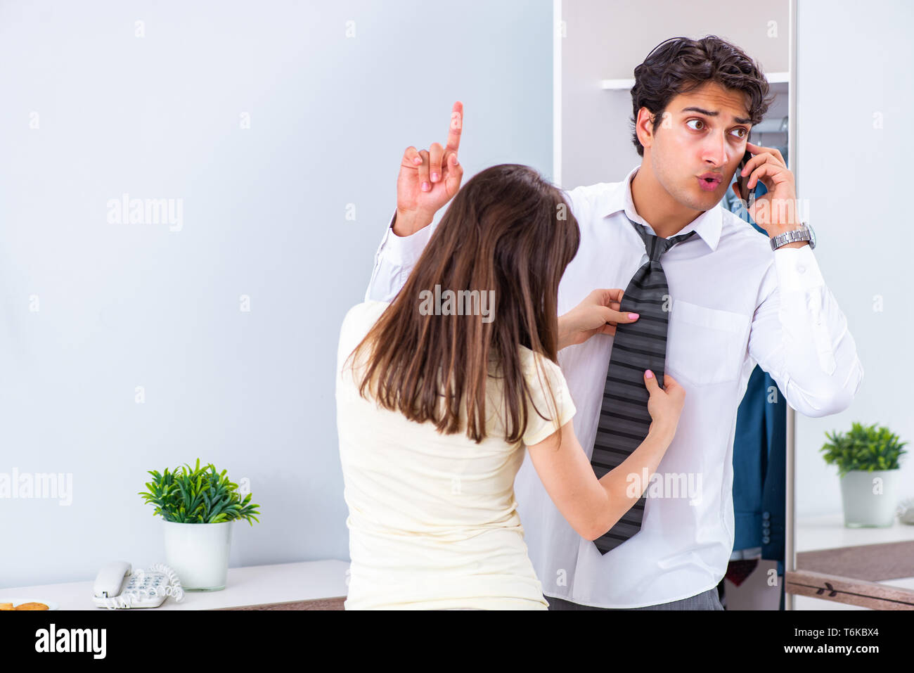 Woman sees her husband off to work Stock Photo - Alamy