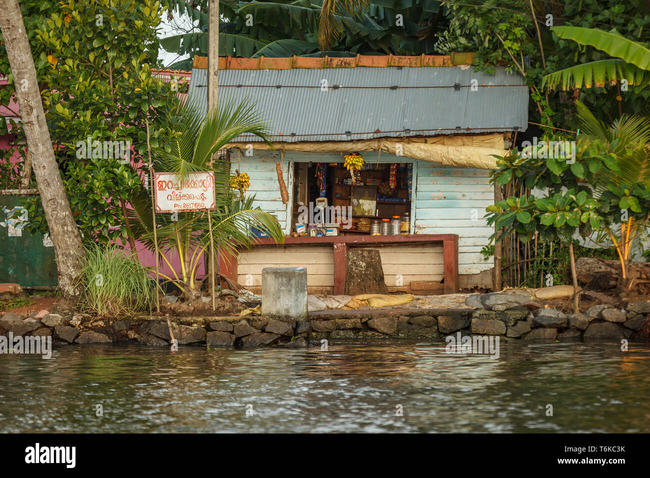 Closeup of riverfront bar and little store in jungle in Alleppy India ...