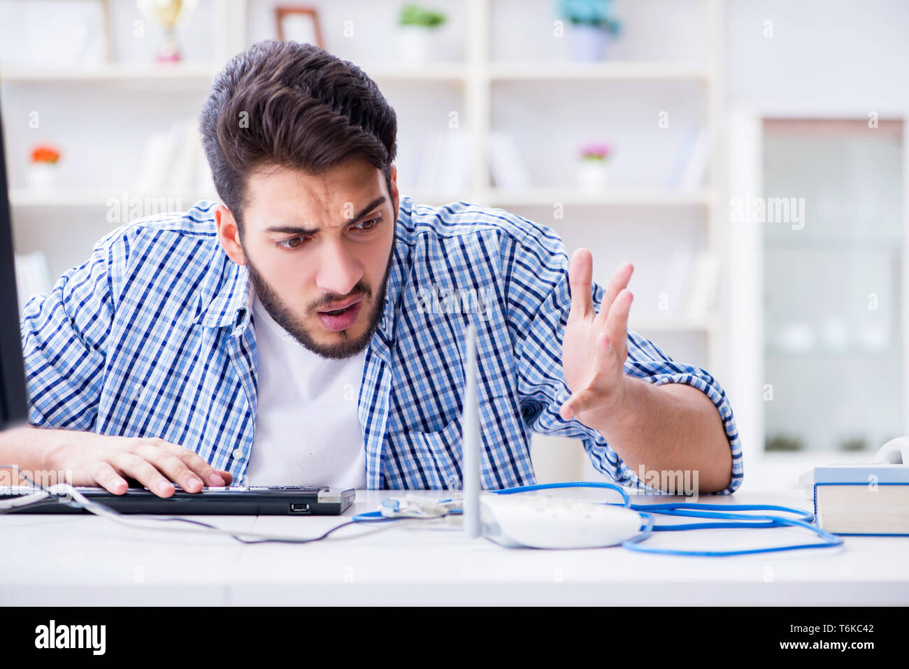 Frustrated young man due to weak internet reception Stock Photo - Alamy