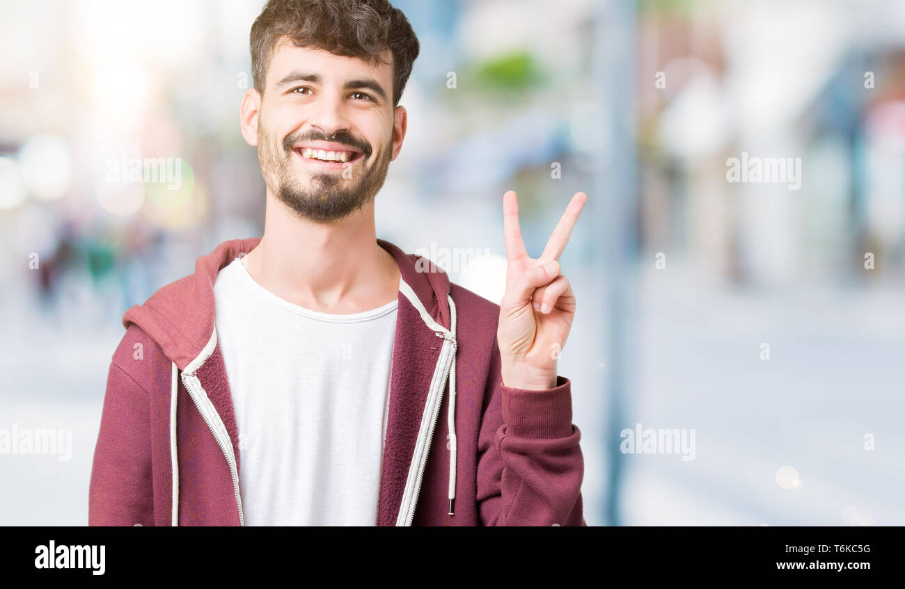 Young handsome man over isolated background smiling with happy face ...