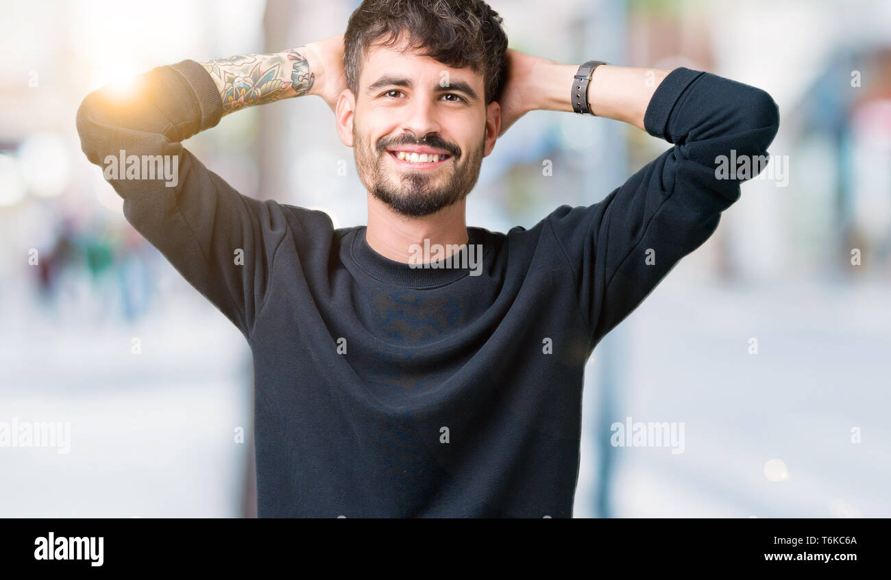 Young handsome man over isolated background Relaxing and stretching ...