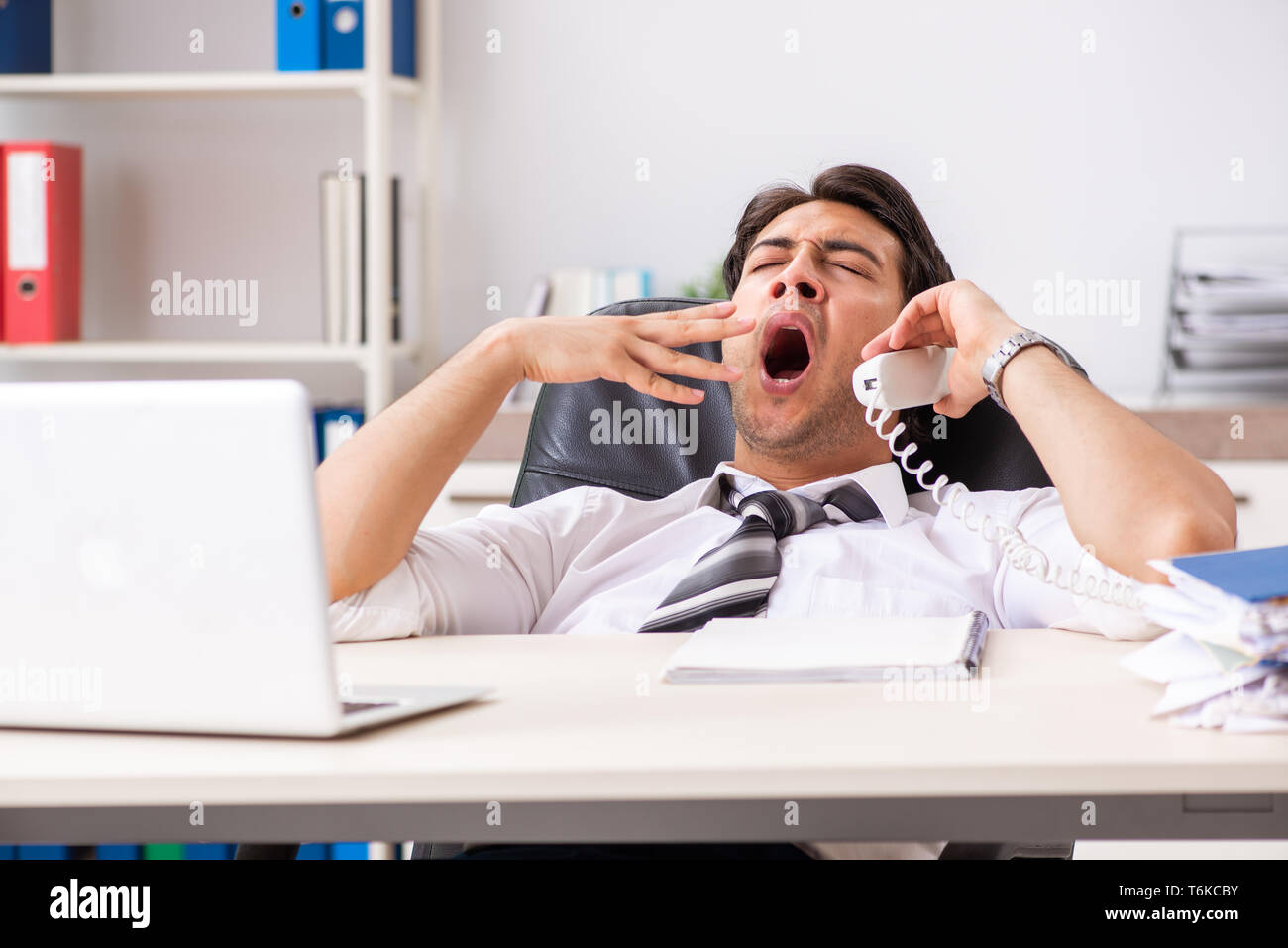 Young call center operator speaking on phone Stock Photo - Alamy