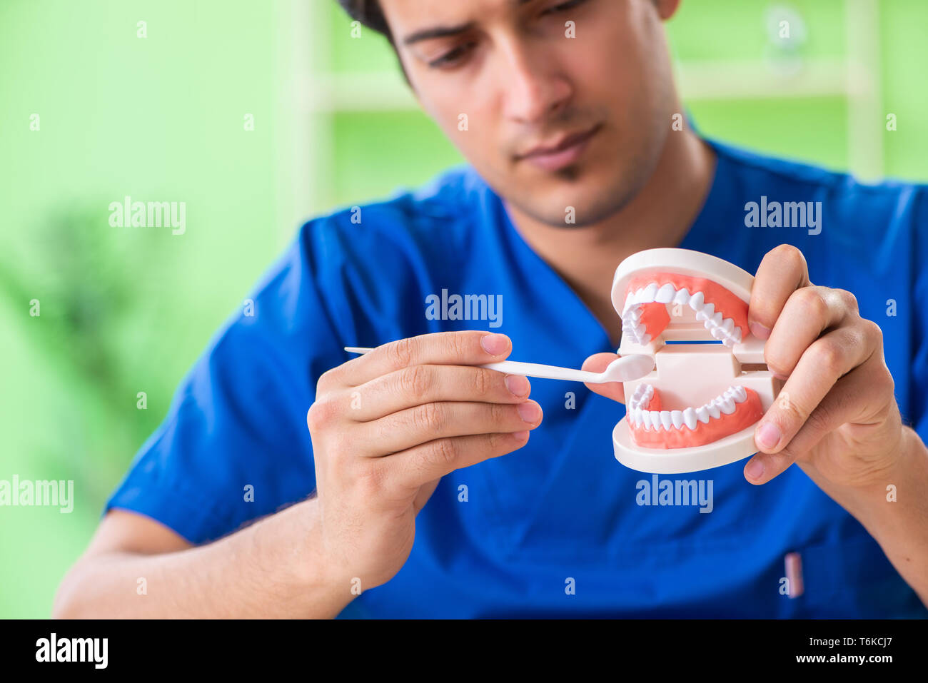 Man dentist working on new teeth implant Stock Photo - Alamy