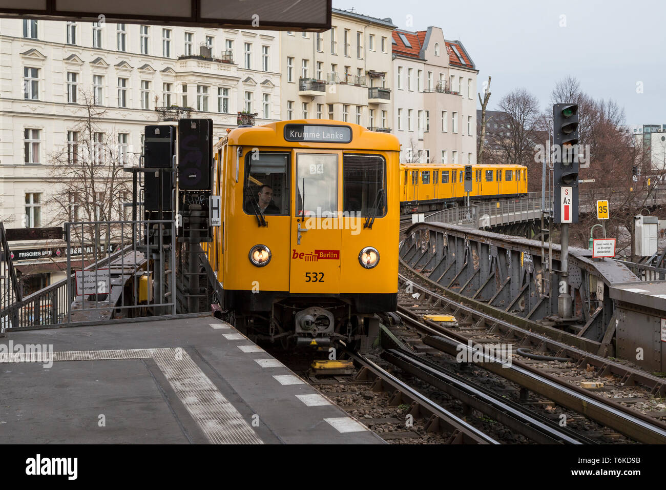 Old yellow U-Bahn subway train approaching an overground station in ...