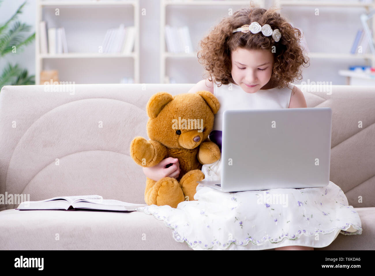 Little girl surfing internet on laptop Stock Photo - Alamy