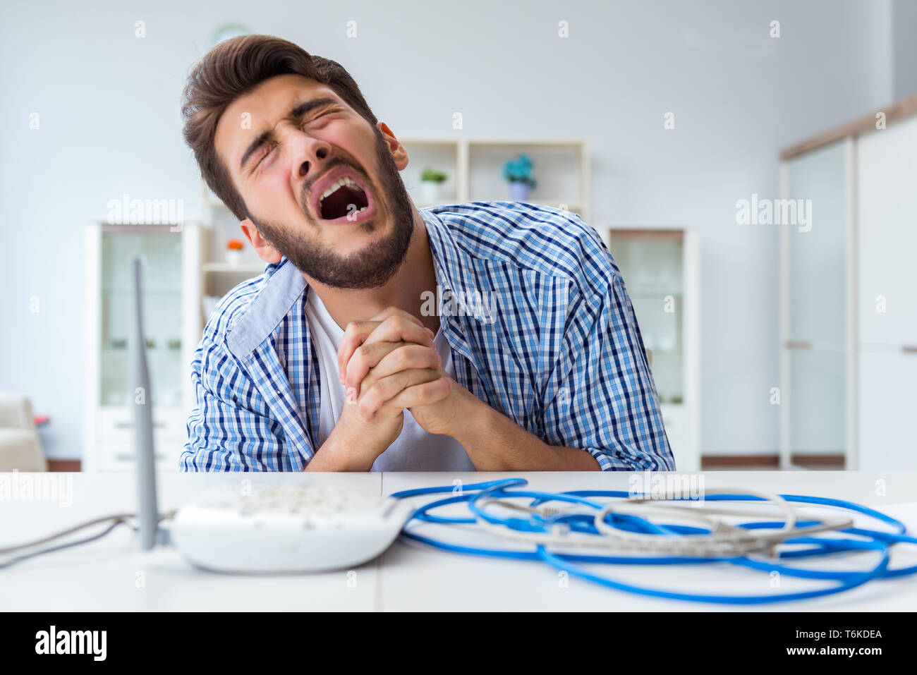 Frustrated young man due to weak internet reception Stock Photo - Alamy