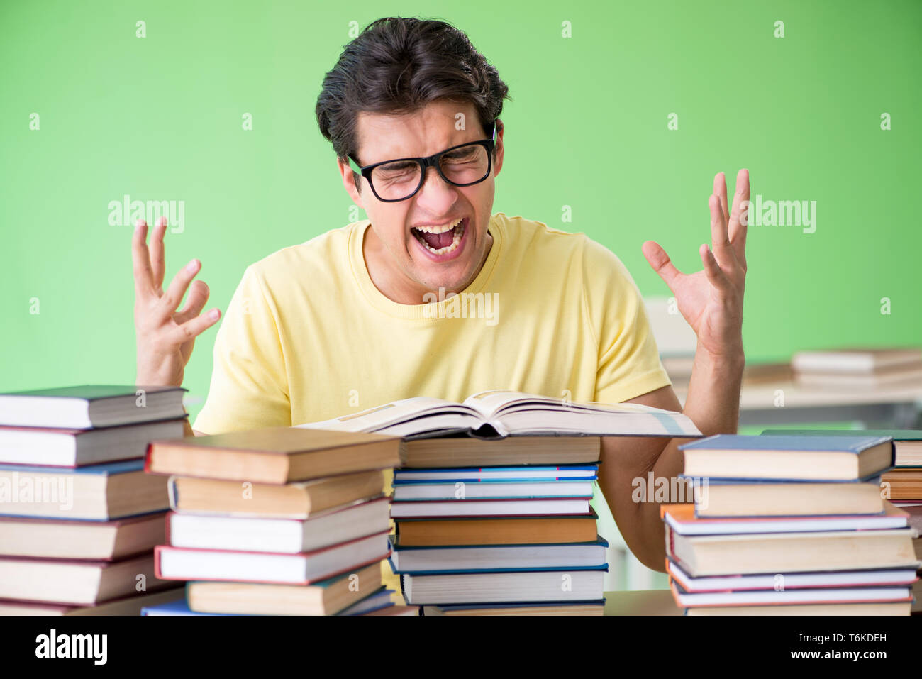 Student with too many books to read before exam Stock Photo - Alamy