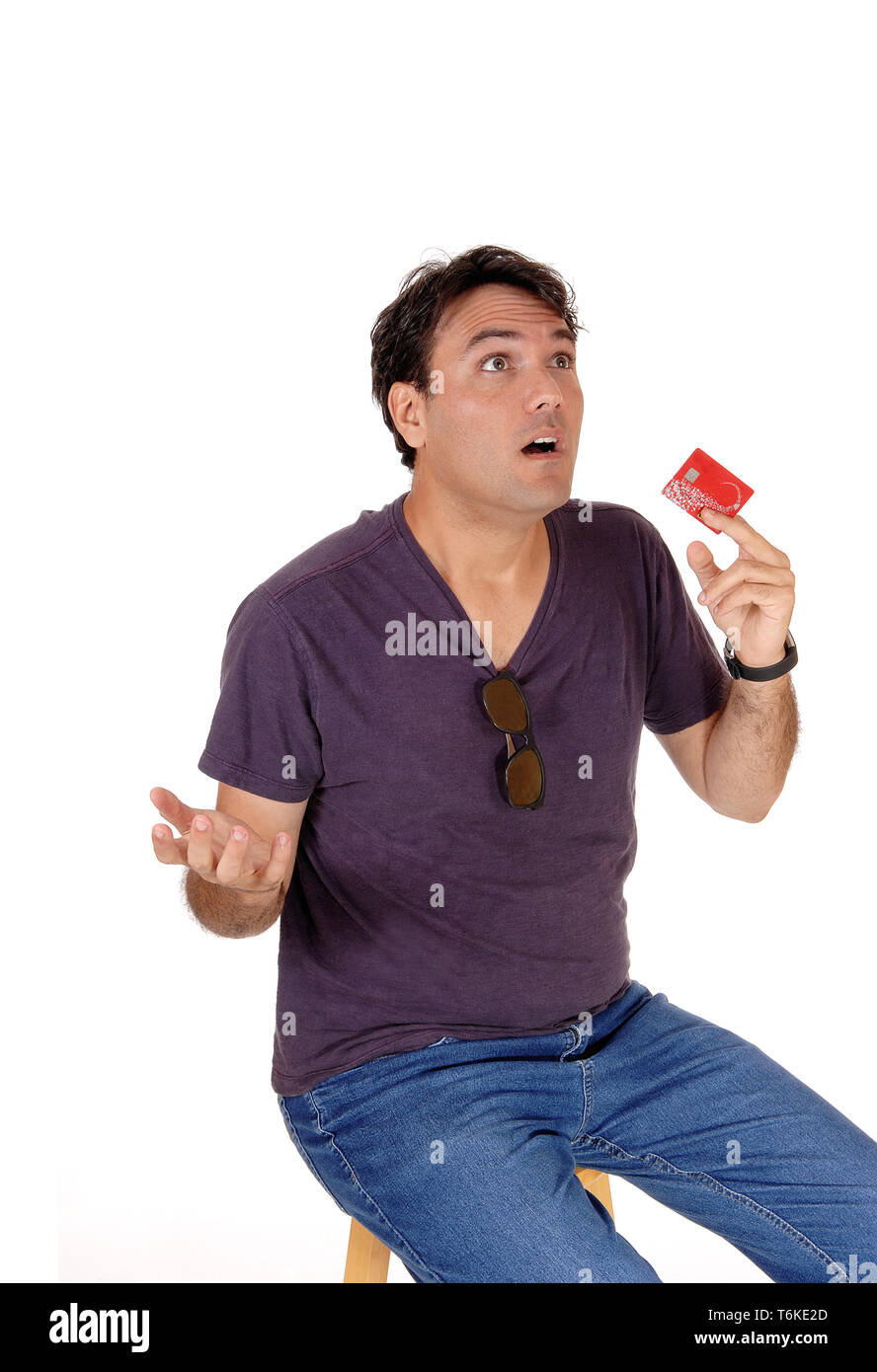 Surprised man holding credit card Stock Photo - Alamy