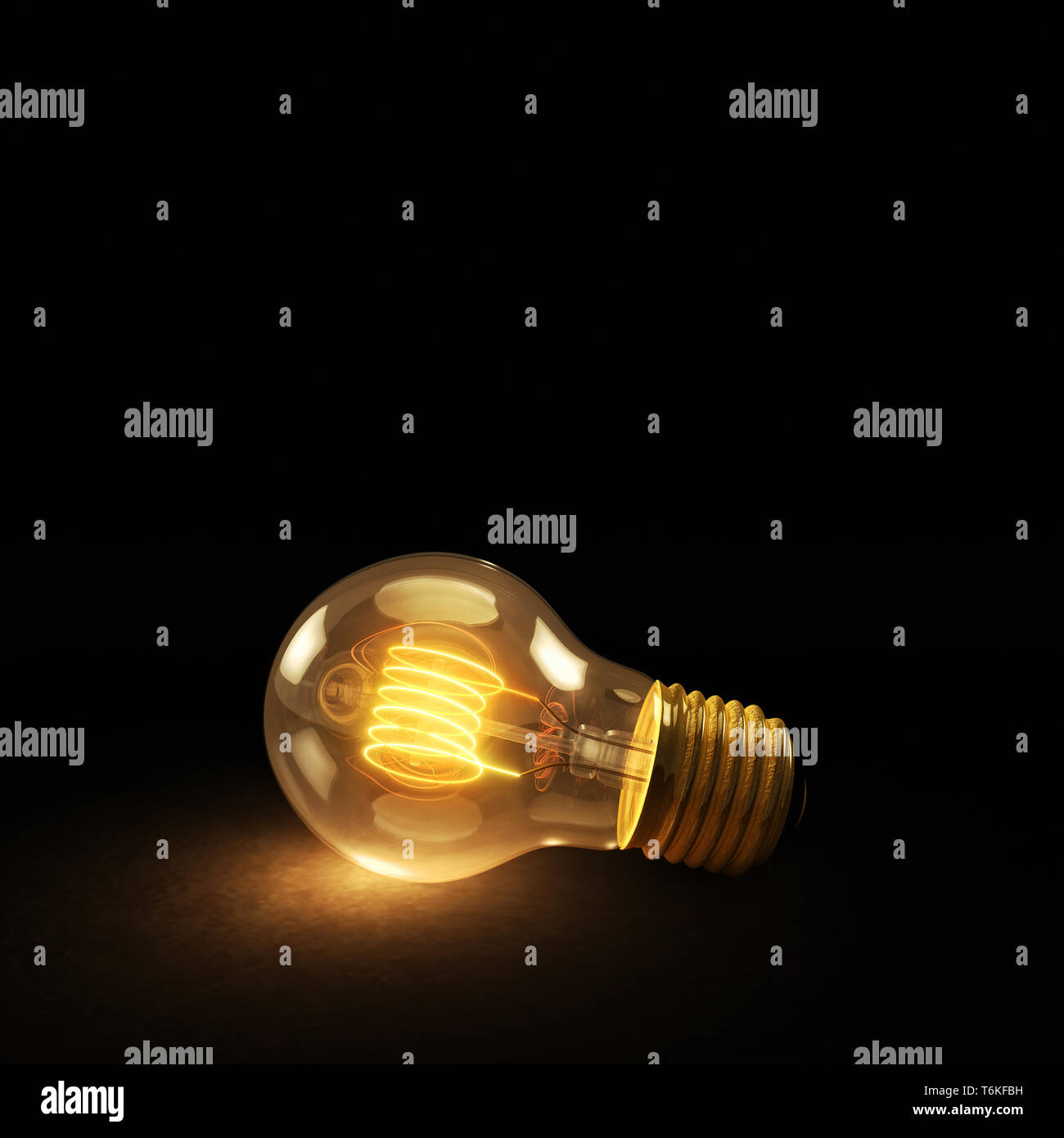 Glowing Incandescent Light Bulb Lying Sideways on a Dark Background ...