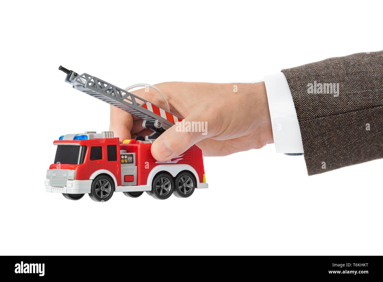 Hand with fire truck Stock Photo - Alamy