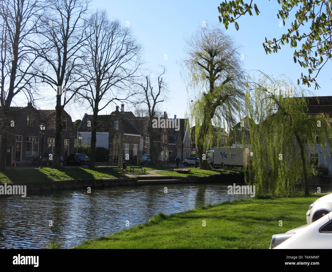 View of houses alongside a pretty canal on a bright spring day in Edam ...