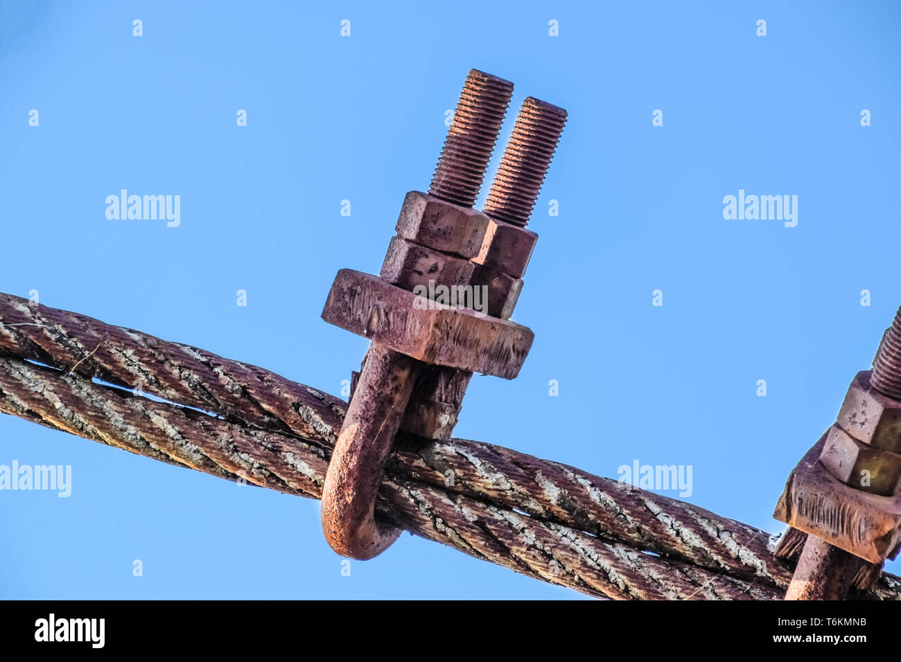 Fastening clamp on the steel cable of the bridge. Connecting elements ...