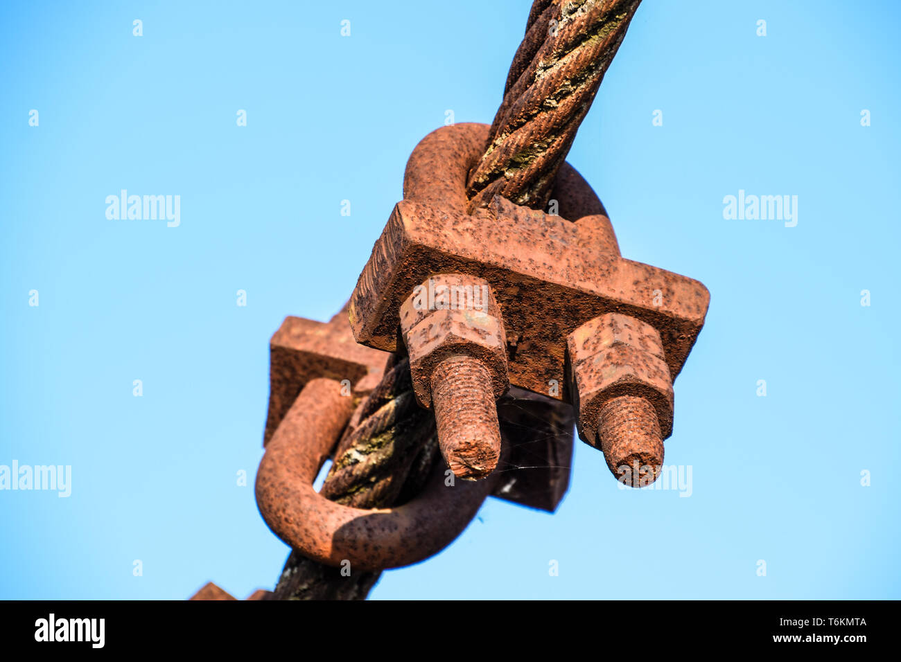 Fastening clamp on the steel cable of the bridge. Connecting elements ...