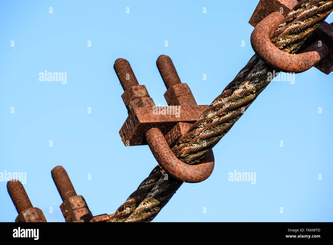 Fastening clamp on the steel cable of the bridge. Connecting elements ...
