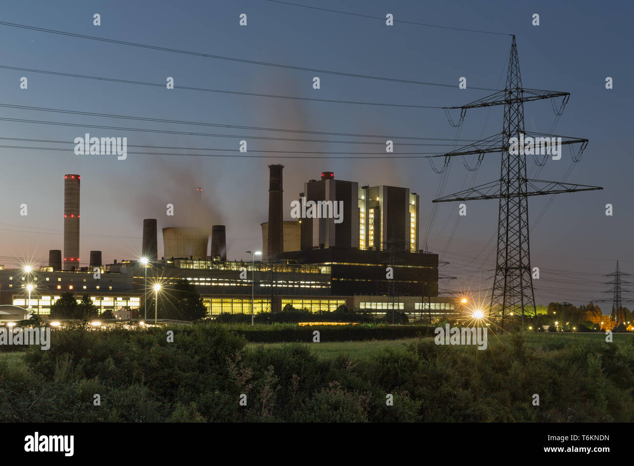 Sunset view at power plant with electricity pylon in Germany Stock ...