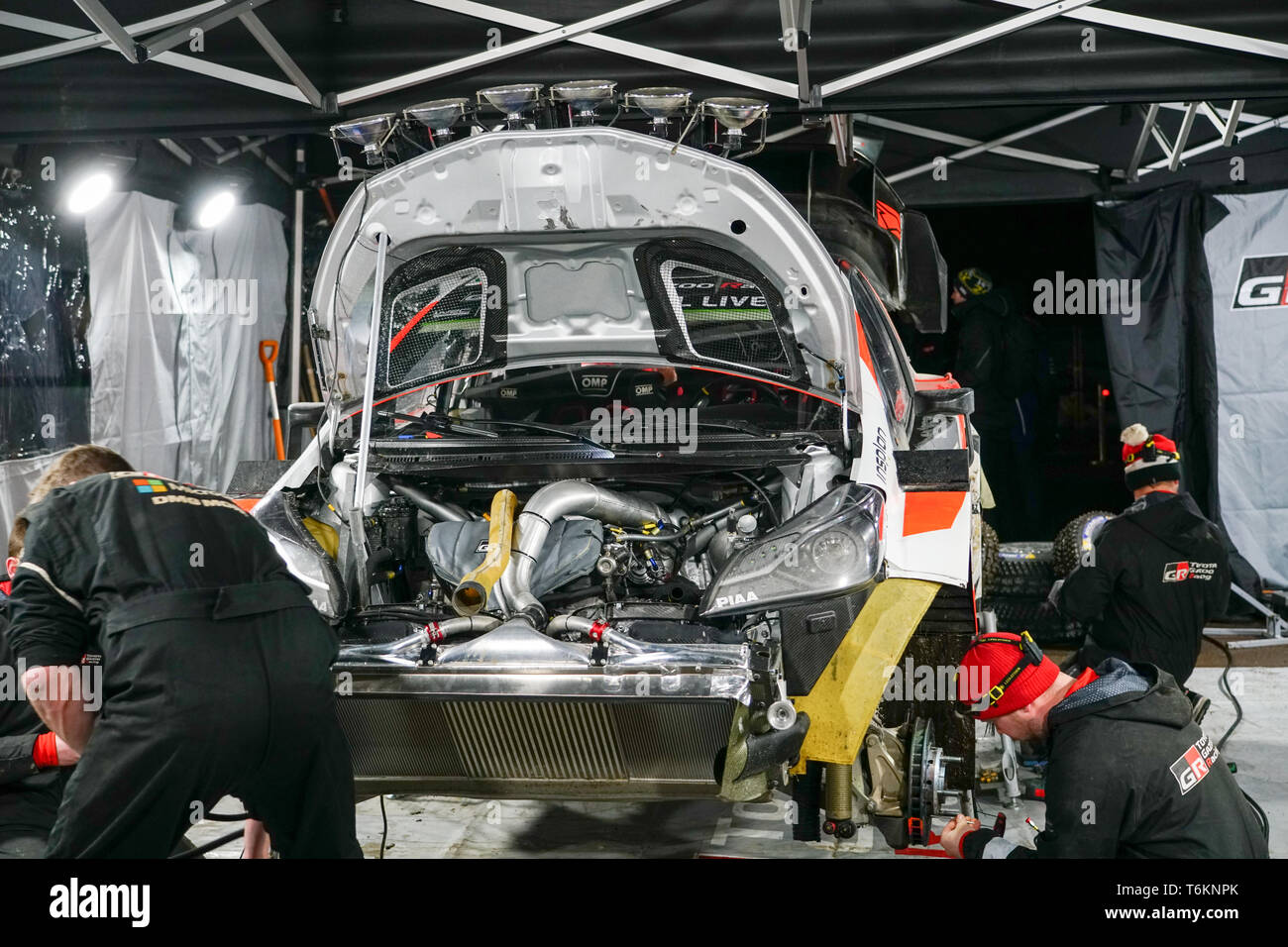 Mechanics making the last preparations to the rally car before leaving ...