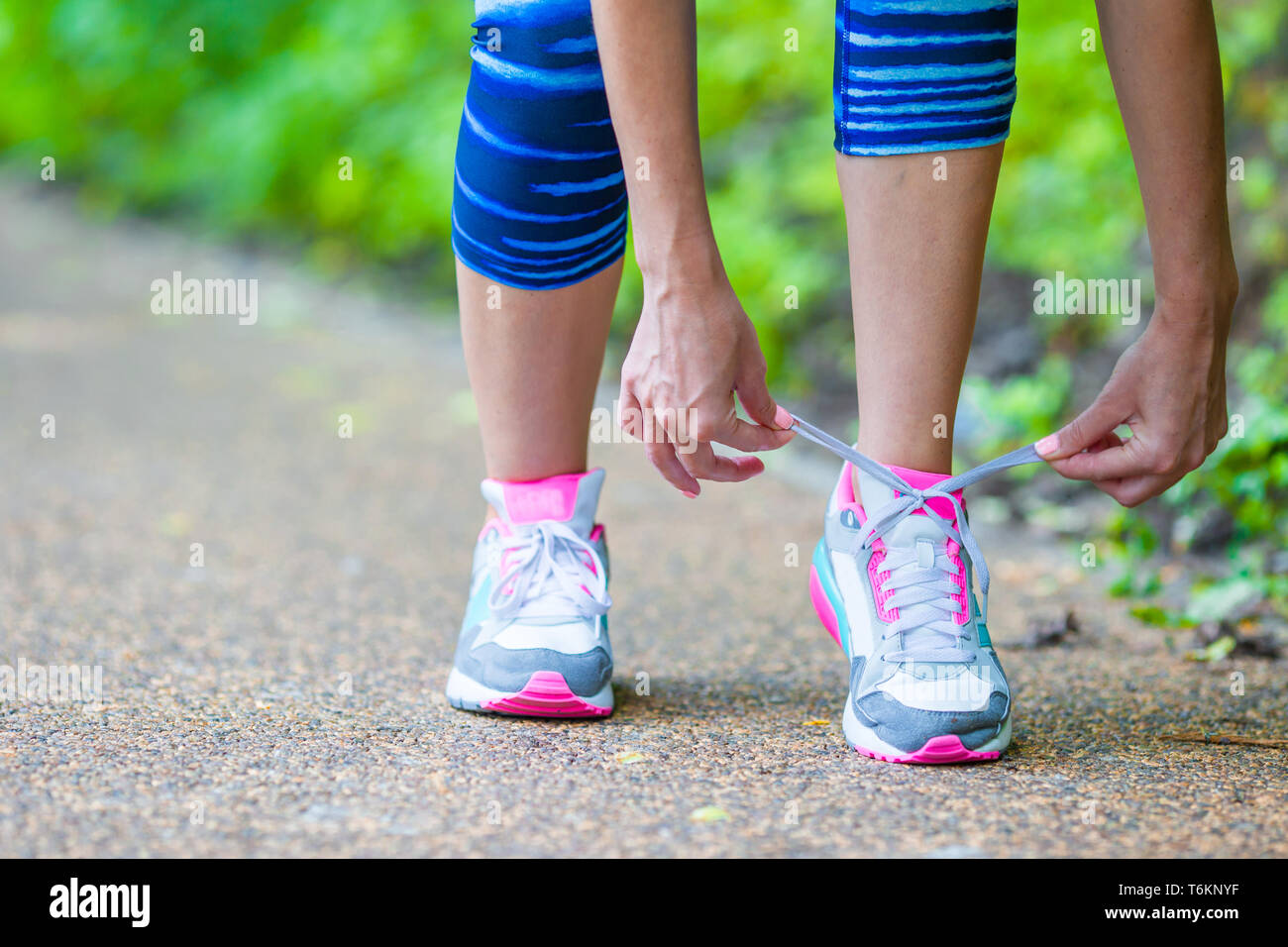 Close-up on shoe of athlete runner woman feet running on road Stock ...