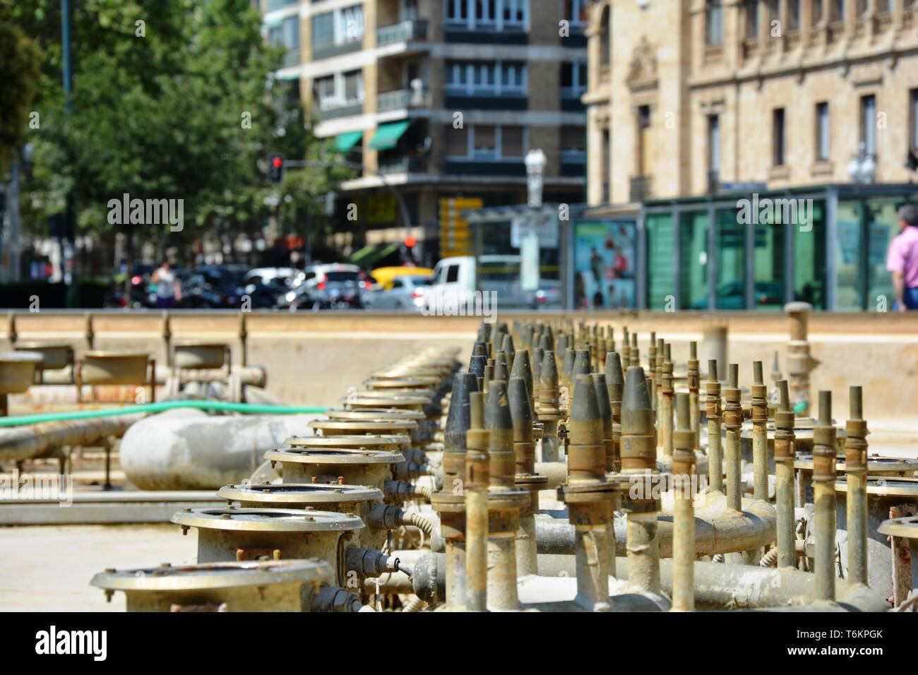 an empty fountain, floodlights, piping and buildings Stock Photo - Alamy