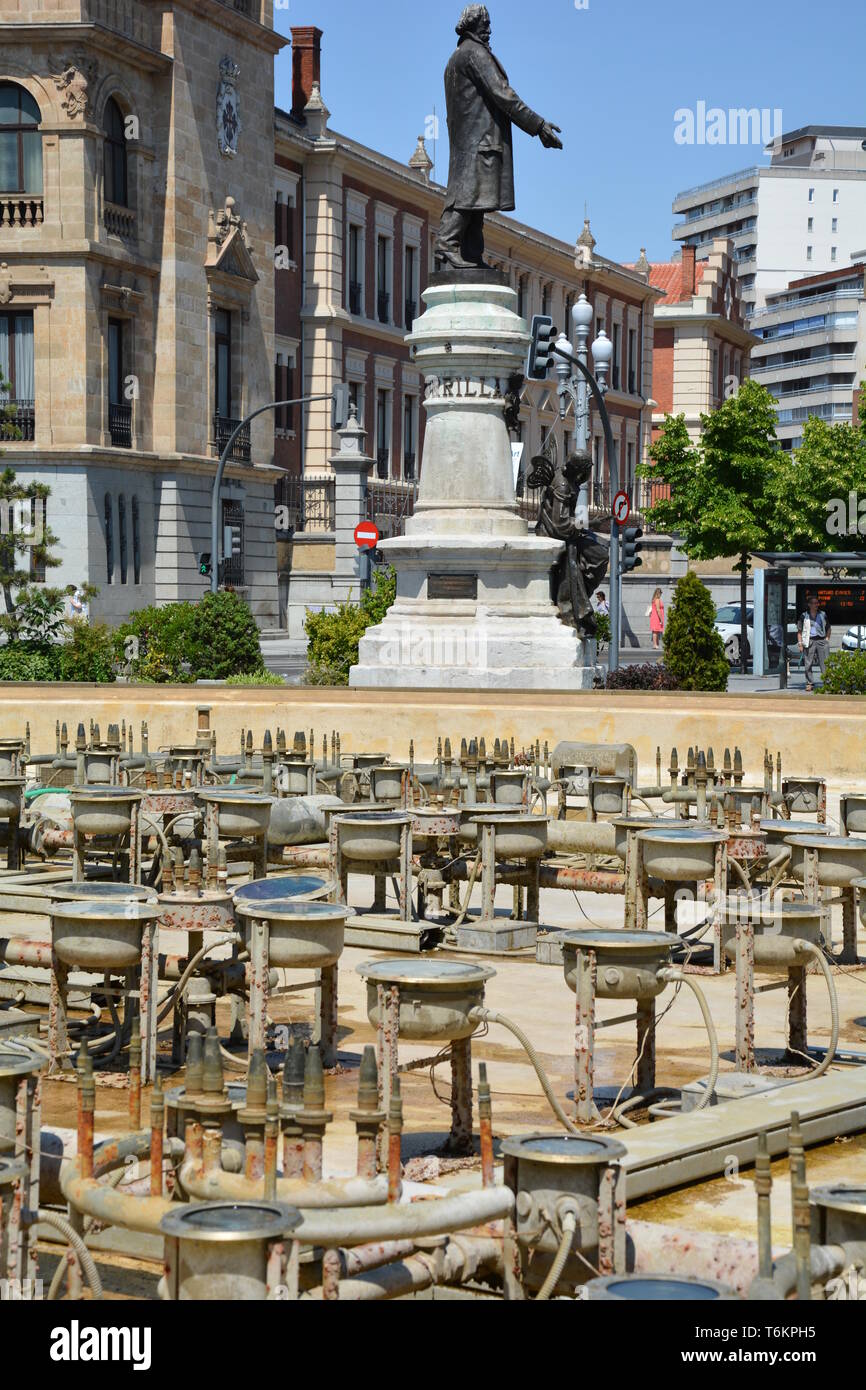 an empty fountain, floodlights, piping one statue and a listed building ...