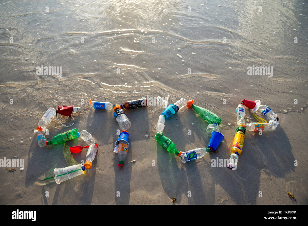 MIAMI - JULY, 2018: 'Stop' spelled out in the sand using garbage ...
