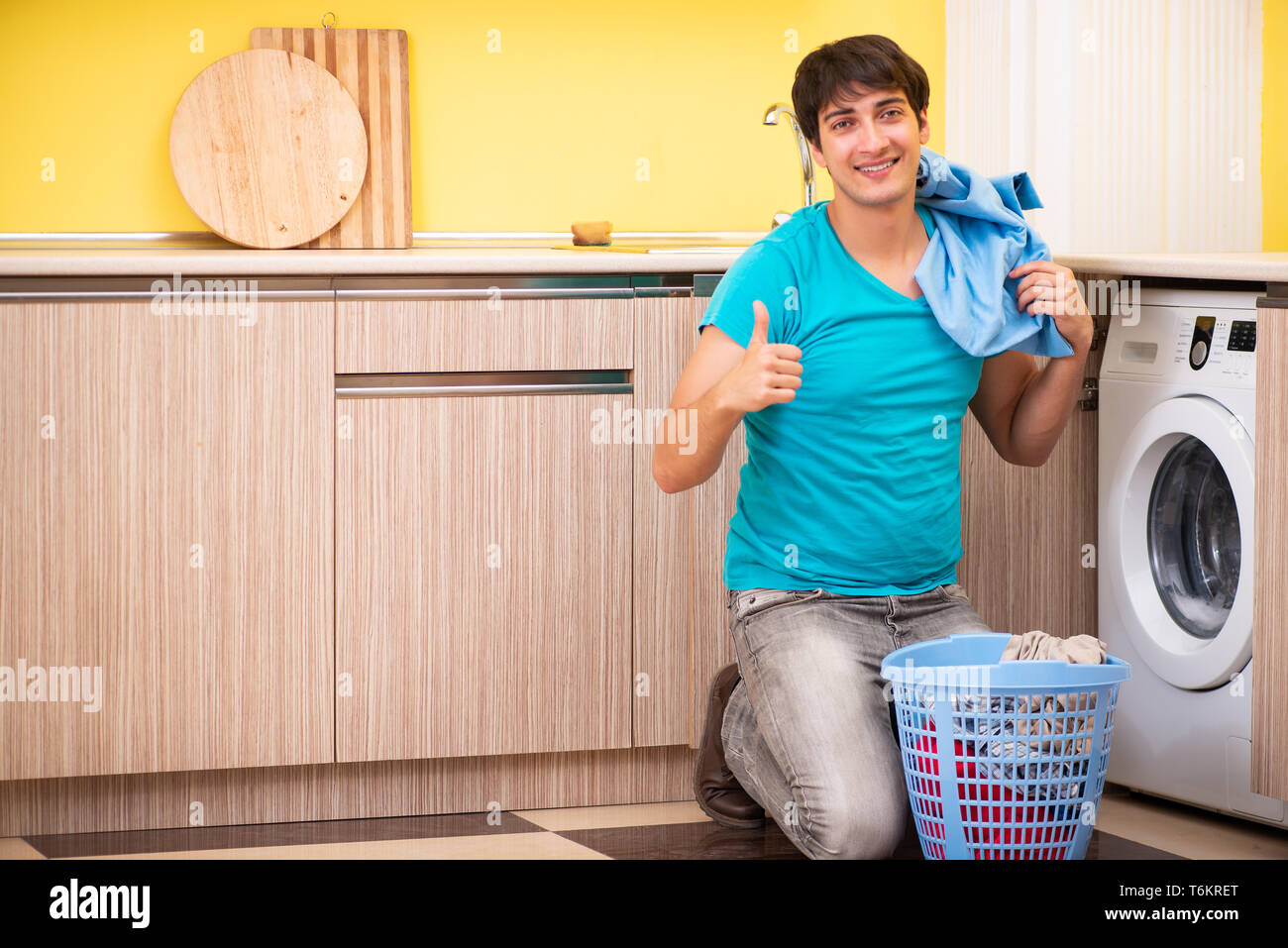 Young husband man doing laundry at home Stock Photo - Alamy