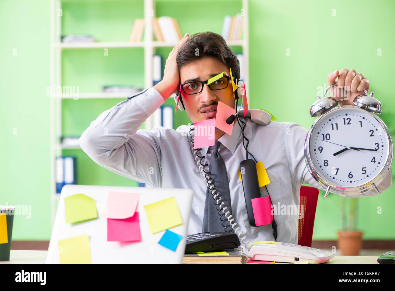 Young help desk operator working in office with many conflicting Stock ...