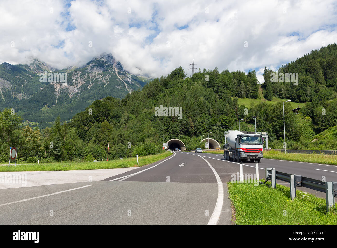 Austrian highway with cars leaving a tunnel through a mountain Stock ...