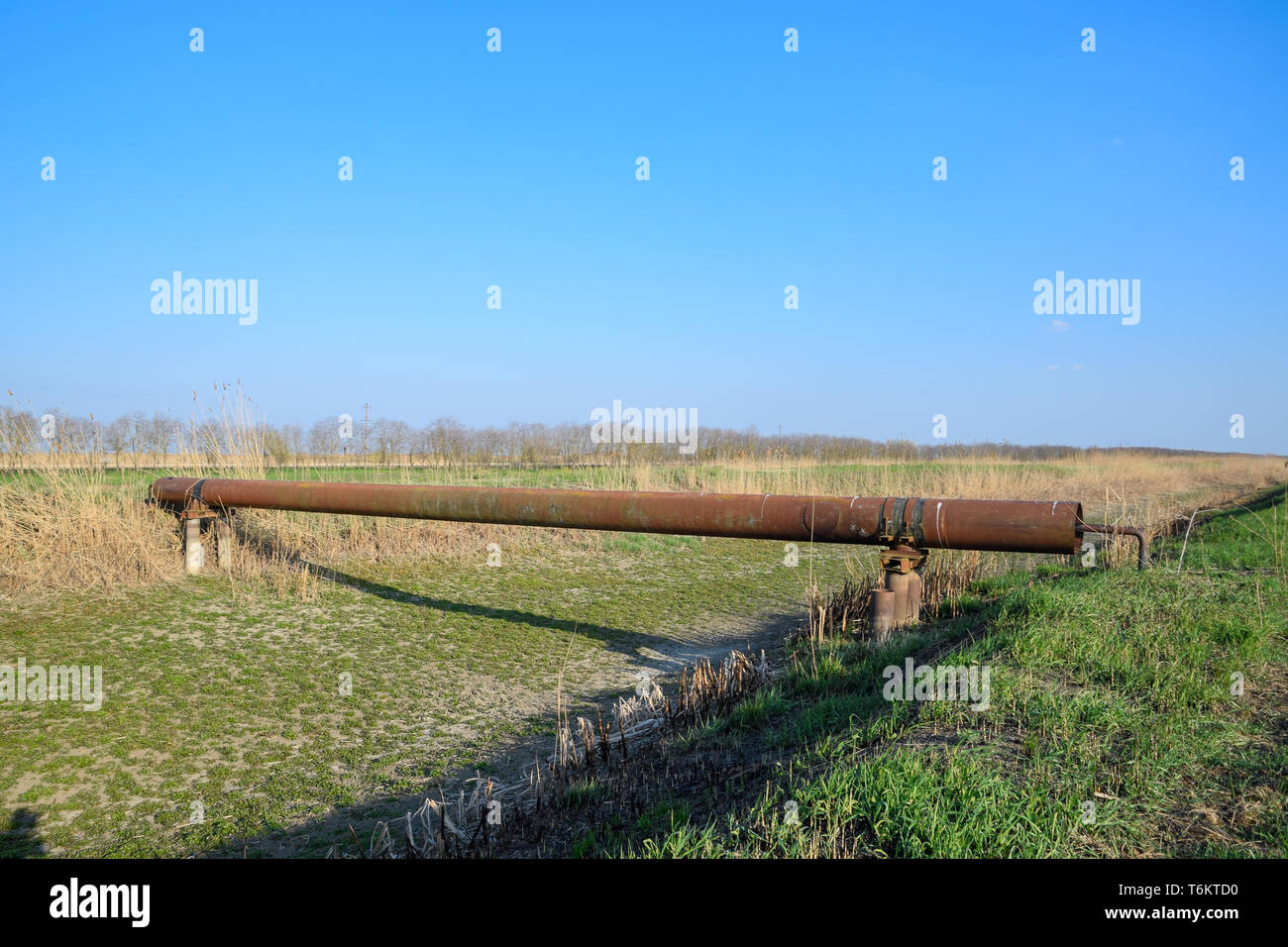 Gas pipeline through the irrigation canal in a protective steel pipe ...