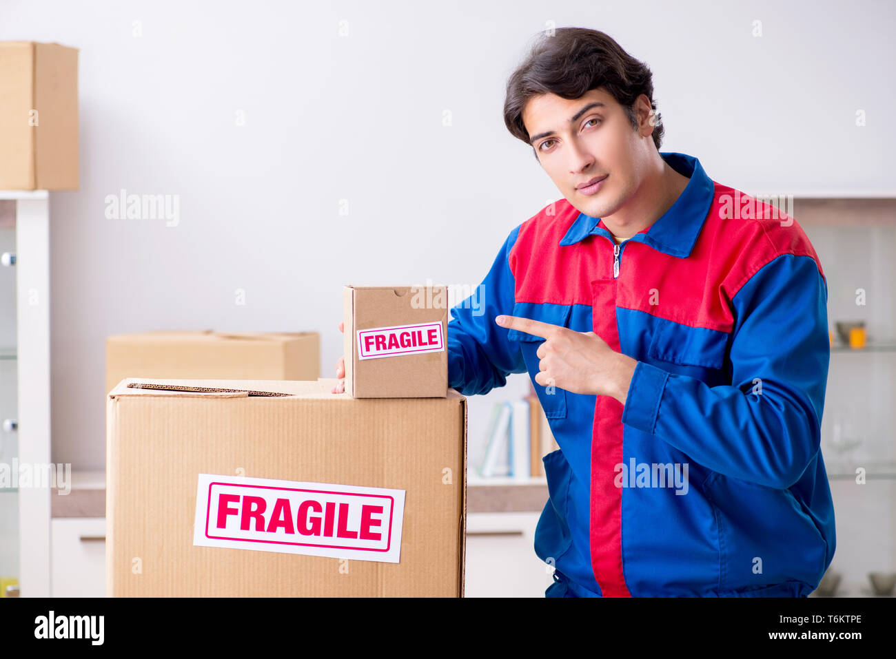 Transportation contractor with fragile boxes Stock Photo - Alamy