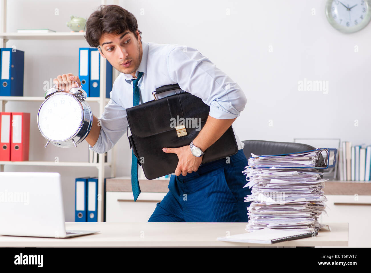 Overloaded busy employee with too much work and paperwork Stock Photo ...