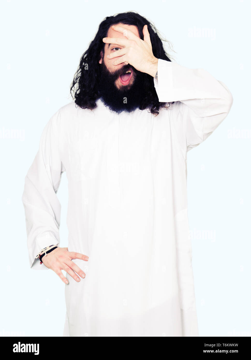 Man wearing Jesus Christ costume peeking in shock covering face and ...