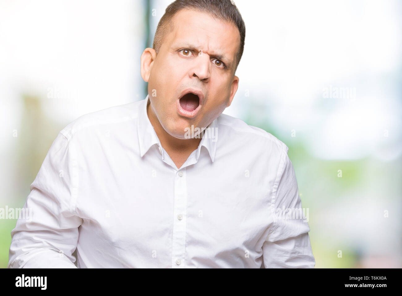 Middle age arab elegant man over isolated background In shock face ...