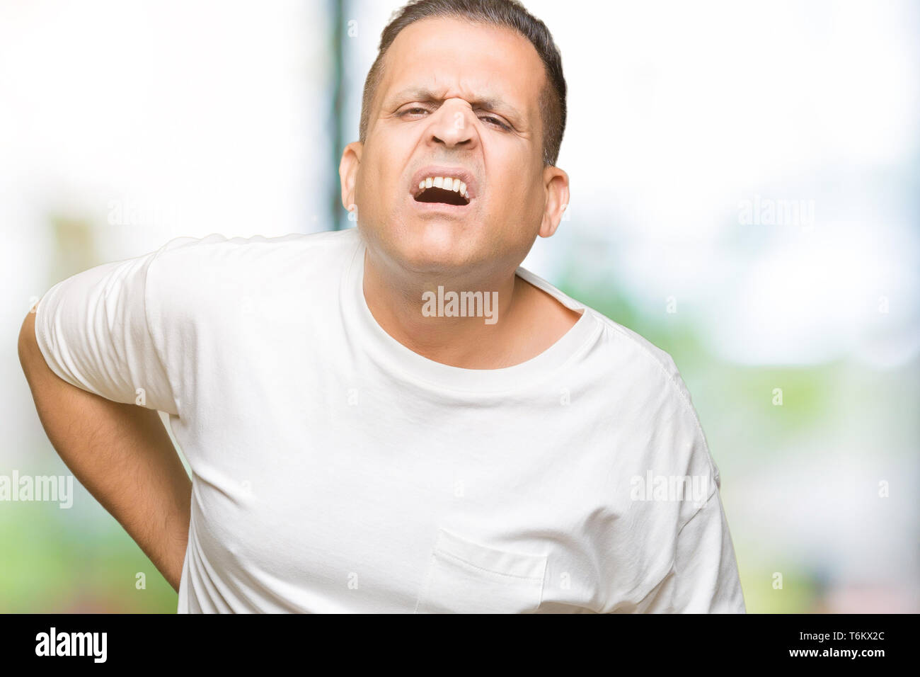 Middle age arab man wearig white t-shirt over isolated background ...