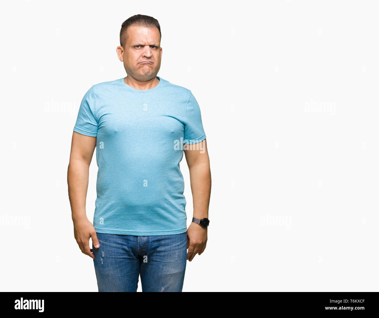 Middle age arab man wearing blue t-shirt over isolated background ...