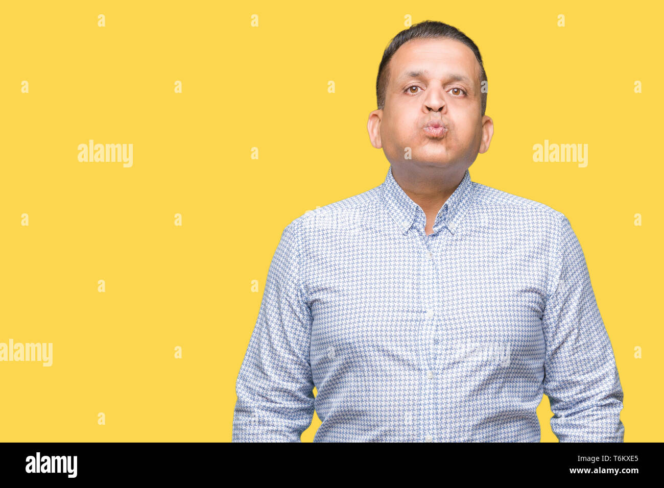 Middle age arab business man over isolated background puffing cheeks ...