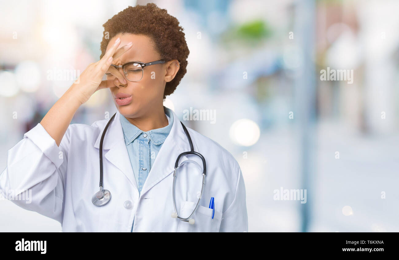 Young african american doctor woman wearing medical coat over isolated ...