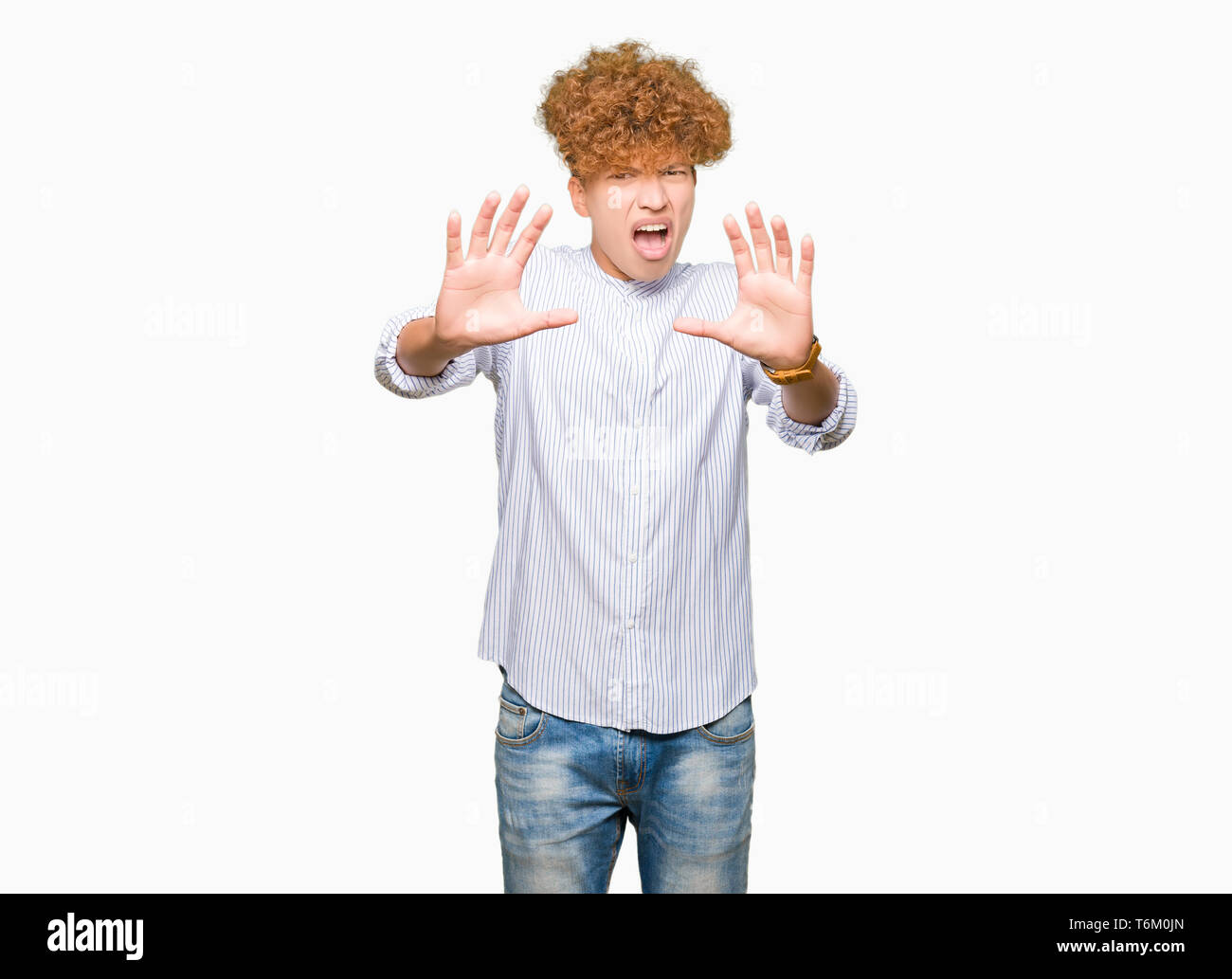 Young handsome business man with afro hair wearing elegant shirt afraid ...