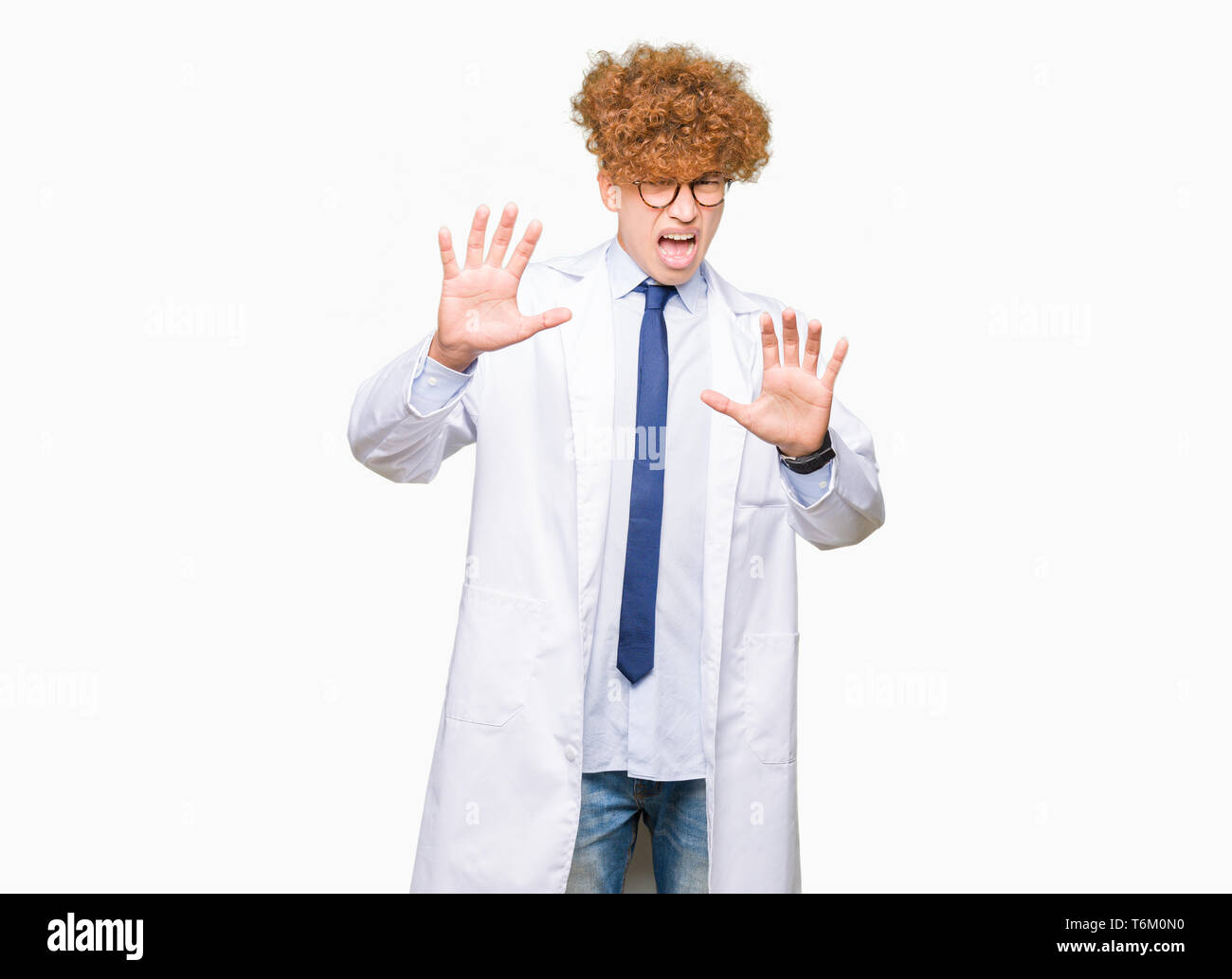 Young handsome scientist man wearing glasses afraid and terrified with ...