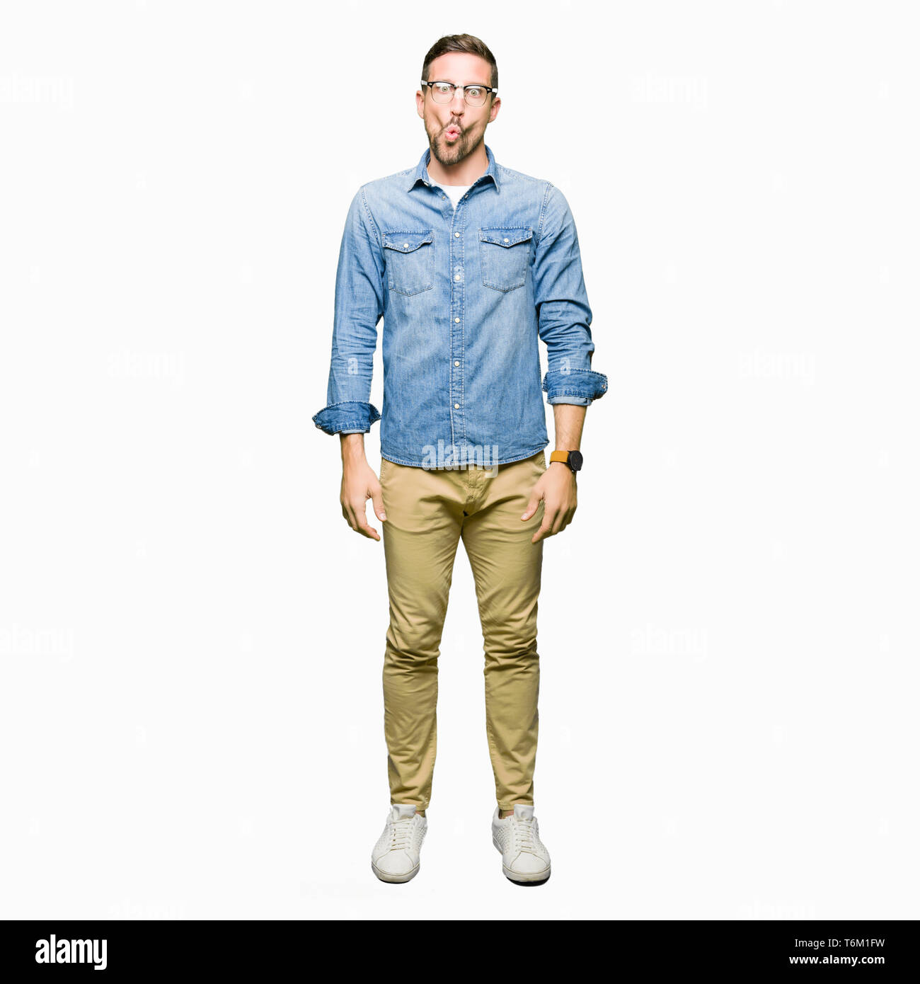 Handsome man wearing glasses making fish face with lips, crazy and ...